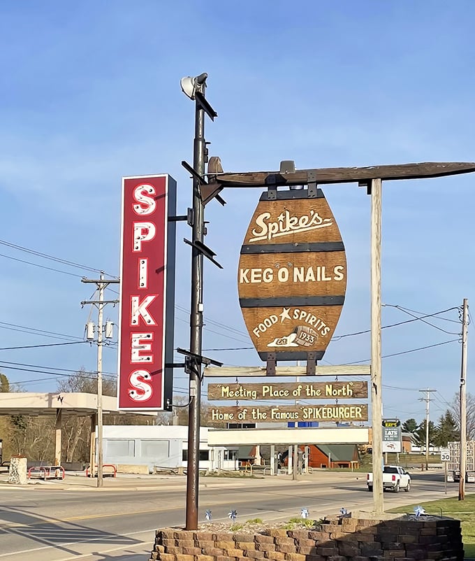 Spike's barrel-shaped sign stands tall against Michigan skies – a North Woods burger beacon for generations of travelers.