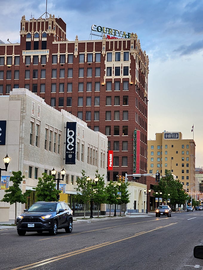 The historic Courtyard building glows with timeless style as Amarillo’s downtown bustles below, blending classic architecture with a lively Texas spirit.