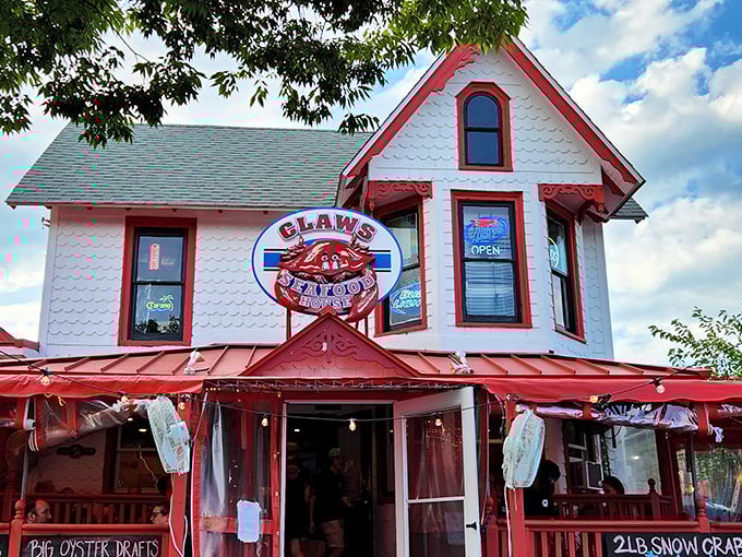 The charming porch at Claws Seafood House invites you to sit a spell and crack some crabs – coastal comfort at its finest.