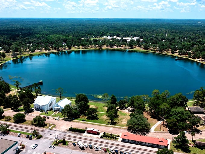 Nature's perfect circle meets Victorian splendor. DeFuniak Springs' lake view makes you wonder if flat Florida was taking geometry lessons here.
