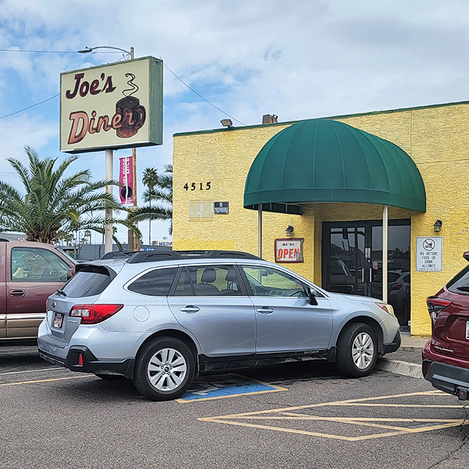That classic green awning isn't just shade from the Arizona sun – it's the entrance to a time machine serving nostalgia on every plate.