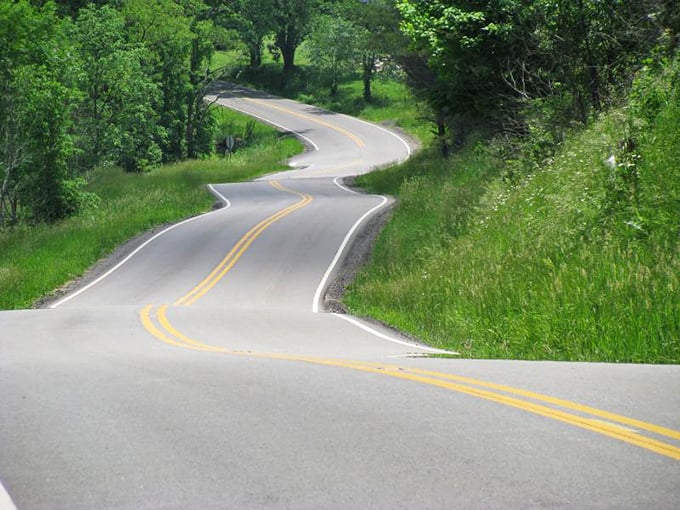 Route 555's serpentine path offers the kind of curves that make driving enthusiasts grin and passengers reach for the grab handle.