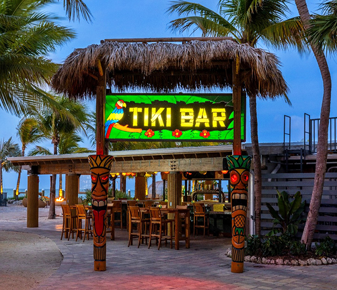 Palm trees, thatched roofs, and endless blue water—this isn't a postcard, it's just another perfect day at Islamorada's iconic Tiki Bar.