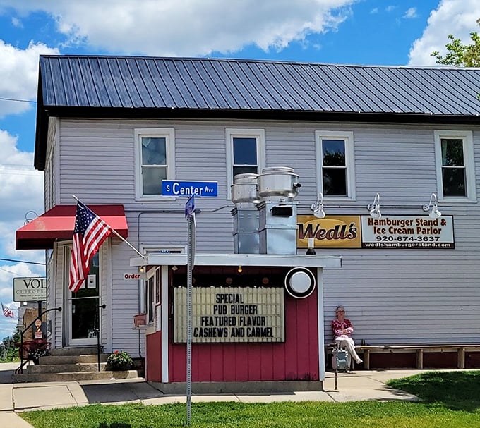 The American flag waves proudly over Wedl's – a fitting tribute to this slice of pure Americana serving burgers the old-fashioned way.