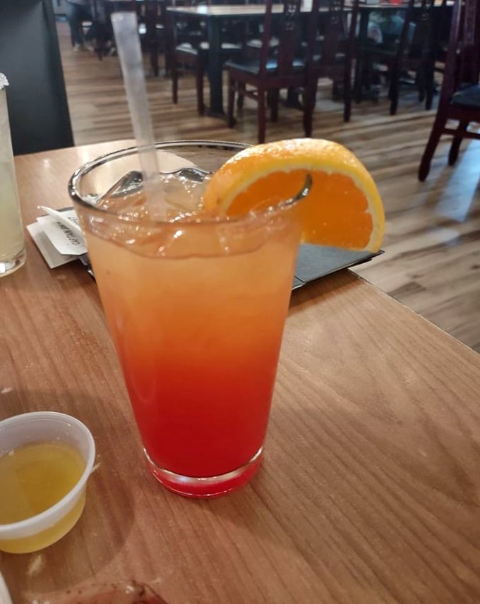 The "American Sunset" cocktail lives up to its name—layers of orange and red that look like Tennessee sky at dusk, but taste like tropical paradise.