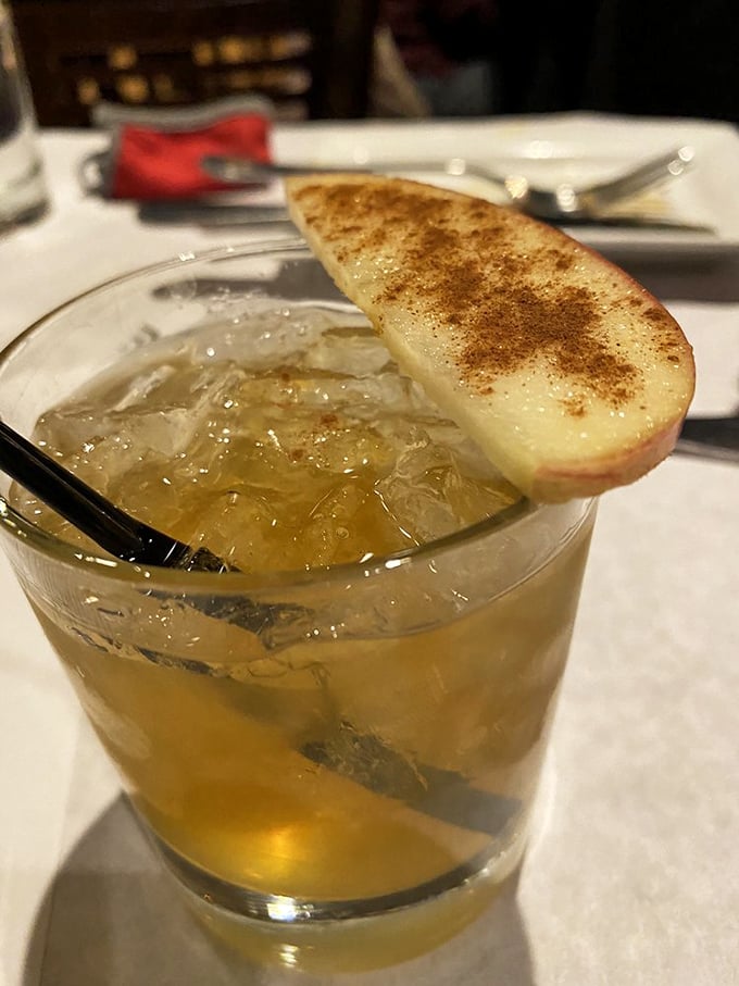 This isn't just a cocktail—it's a liquid dessert with a pedigree, complete with a cinnamon-dusted apple slice crown.