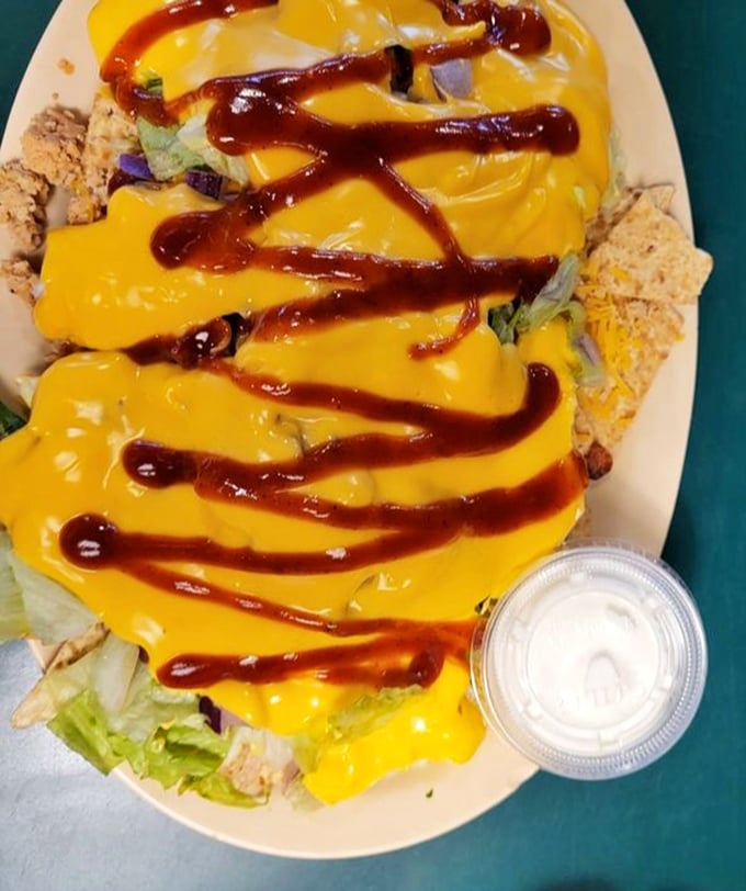 BBQ nachos that throw subtlety out the window. That cheese sauce and barbecue sauce zigzag isn't just for looks—it's a roadmap to flavor town.