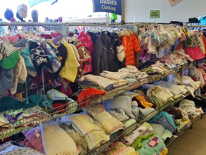 Tiny clothes with big potential fill baskets like pastel promises of adorable future photo opportunities.