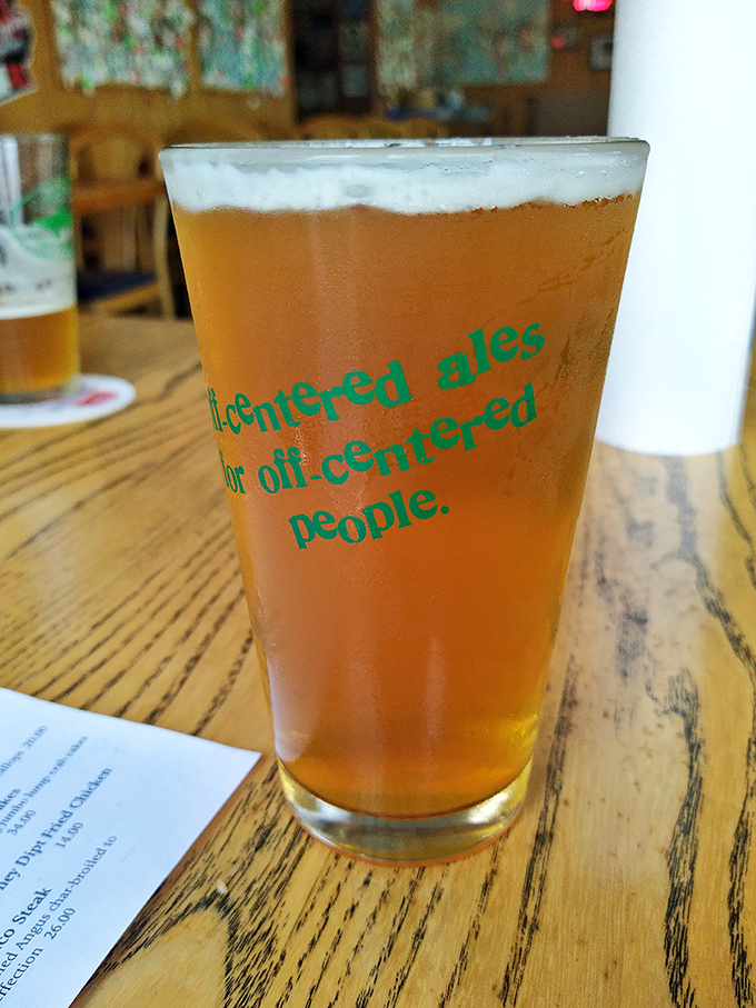 "Off-centered ales for off-centered people"—this glass isn't just holding beer; it's offering a philosophy with your meal.