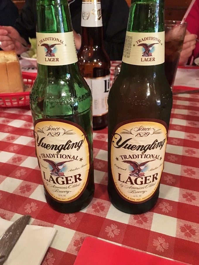 Yuengling bottles standing at attention on classic red-checkered tablecloths – Pennsylvania's liquid pride paired with comfort food is a match made in Keystone State heaven.