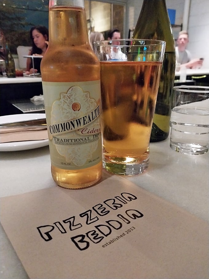 Commonwealth Cider alongside Beddia's menu—proof that Pennsylvania knows how to pair local libations with world-class pizza.