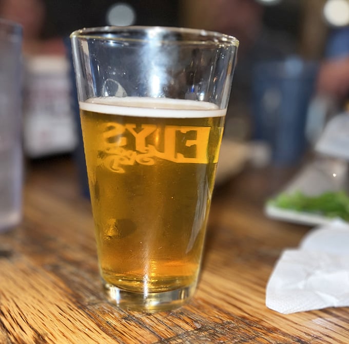 A cold craft beer in a proper glass—civilization's perfect companion to a gourmet burger and the universal signal for "my weekend starts now."