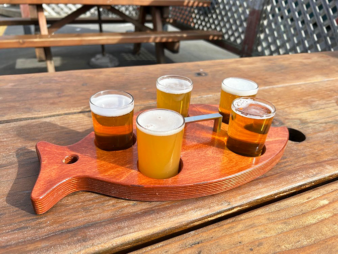 The fish-shaped flight board isn't just cute—it's practical! Four perfect pours of liquid gold, ready to complement whatever oceanic delight you've chosen.