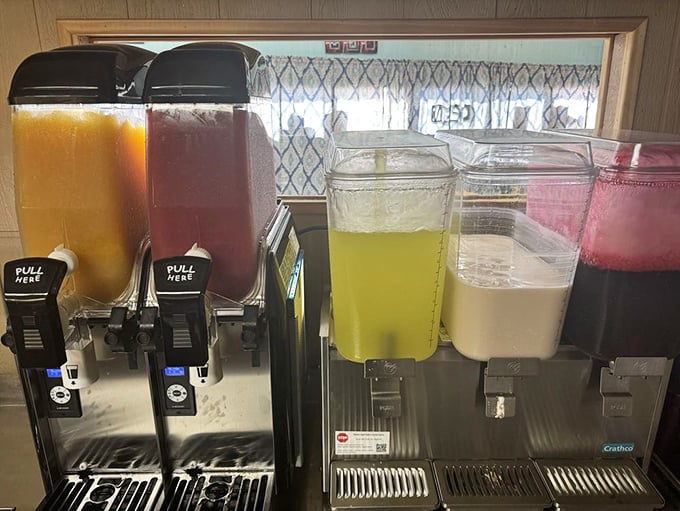 The aguas frescas station—where technicolor refreshment awaits in flavors that bottled sodas can only dream about.