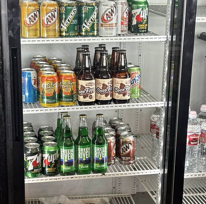 The drink cooler offers liquid companions for your sandwich journey, including that Midwestern favorite – Green River soda in its emerald glory.