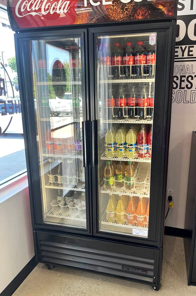 The beverage cooler stands ready – because tackling a proper cheesesteak requires proper hydration support. Choose your companion wisely.