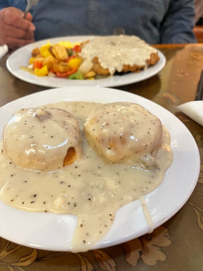 Biscuits drowning in creamy sausage gravy – a breakfast that says "go back to bed after this." Worth every delicious calorie.