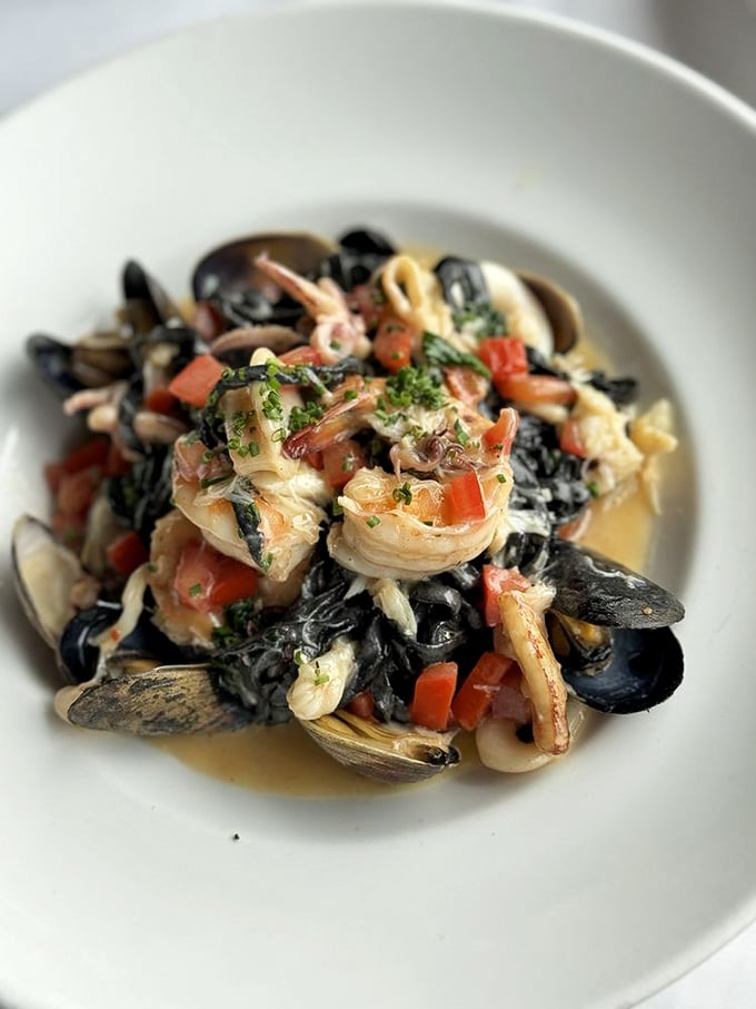 Black pasta swimming with seafood treasures—like finding the perfect little black dress that also happens to taste magnificent.