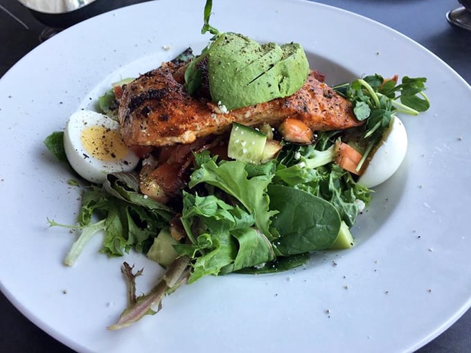 This blackened salmon Cobb isn't just a salad; it's what happens when California's bounty meets New Orleans spice in a bowl of green goodness.