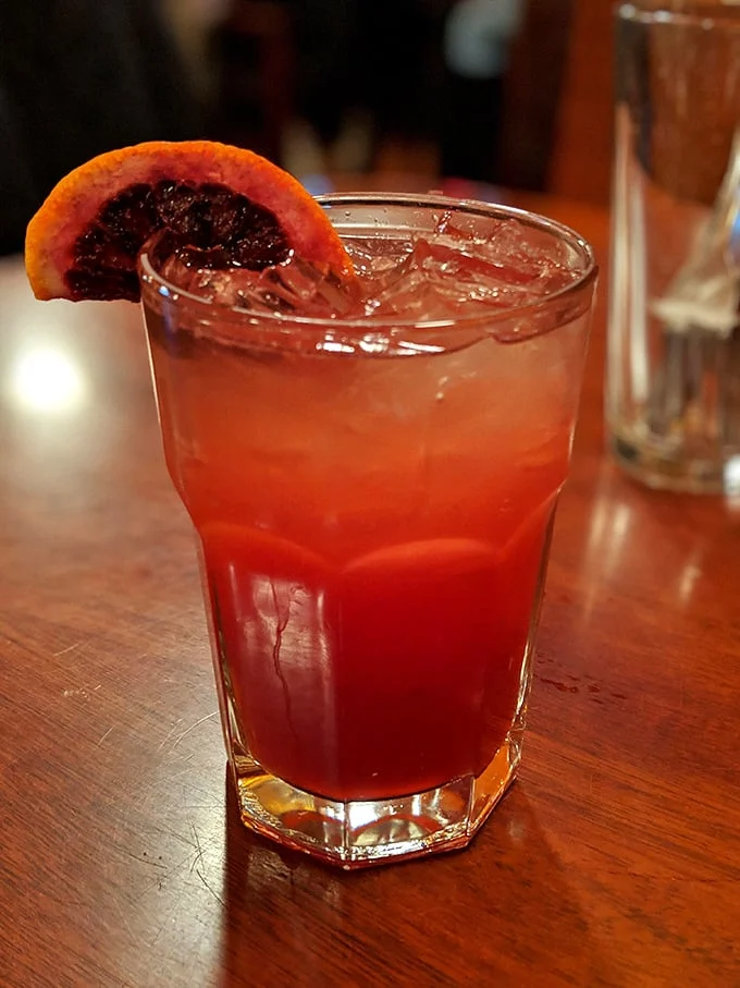 The Blood Orange Collins—proof that cocktails can complement barbecue without starting a flavor civil war. Refreshing enough to cut through the richness.