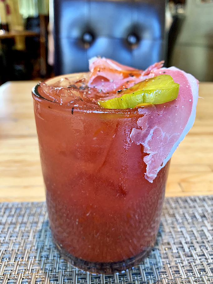 Not your average morning pick-me-up! This Bloody Mary comes dressed for Sunday service with country ham and pickles playing supporting roles.