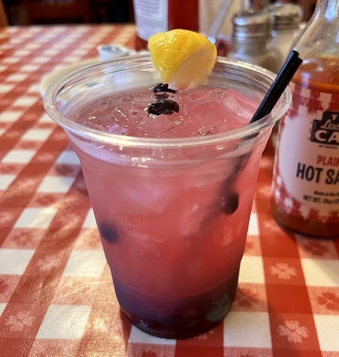 This isn't just blueberry lemonade—it's summer in a glass, sitting pretty next to hot sauce for the perfect Southern contrast.