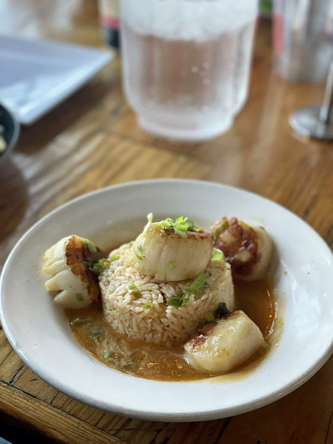 Bourbon butter scallops surrounding a throne of rice—fit for seafood royalty. These caramelized beauties deliver that perfect sweet-savory balance that makes taste buds stand at attention.