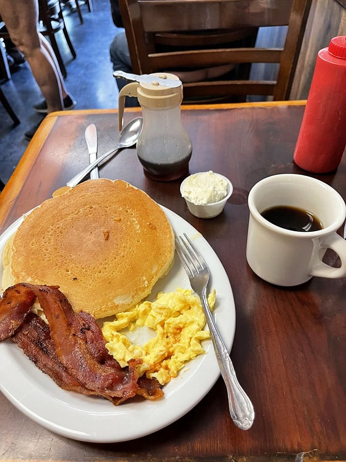Classic diner breakfast executed flawlessly—crispy bacon, fluffy eggs, and a pancake that could double as a pillow. Comfort on a plate.