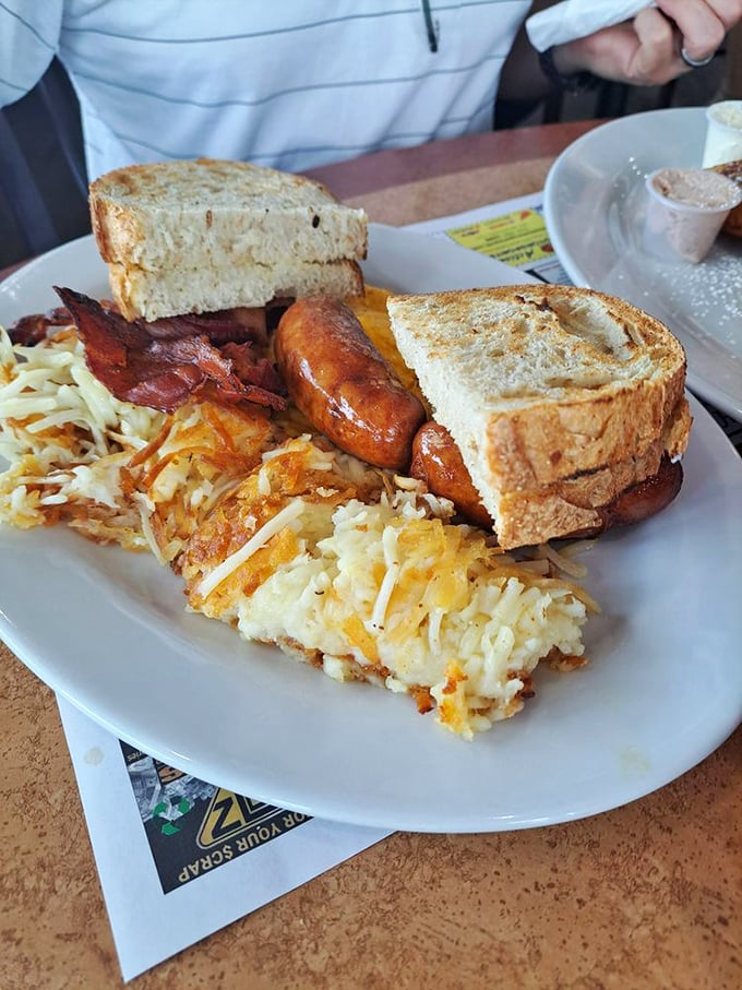 Three sunny-side up eggs lounging atop a bed of home fries—the breakfast equivalent of hitting the jackpot on your first pull.