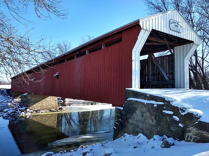 Winter transforms the Eldean Bridge into a scene worthy of the best holiday cards—snow-dusted approaches and the contrast of red against white.