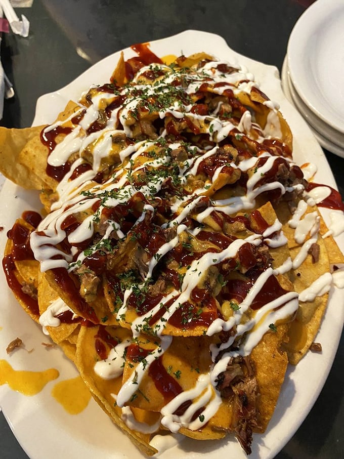 These aren't your average nachos – they're a barbecue masterpiece disguised as bar food, complete with artistic sauce drizzles.