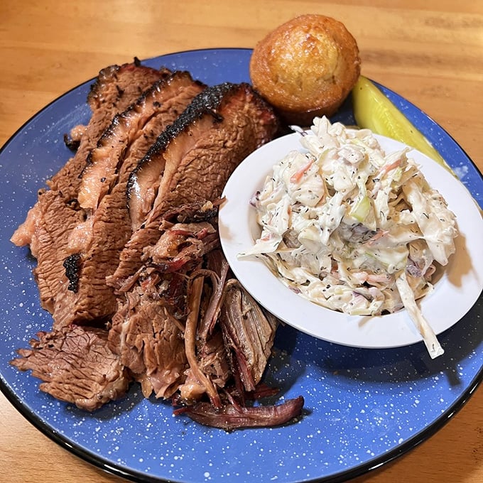 Brisket sliced so perfectly you could frame it. The pink smoke ring is like nature's way of saying, "This was done right, my friend."