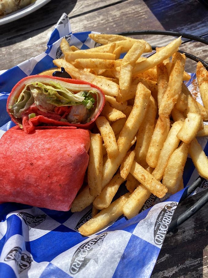 Golden fries surround a wrap that's practically glowing red—like a delicious sunset you can eat without getting sand between your toes. 