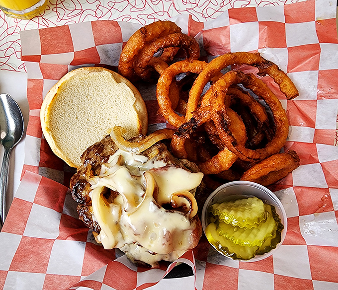 Not all heroes wear capes – some come with melted cheese, caramelized onions and perfect onion rings. This burger deserves its own theme music.