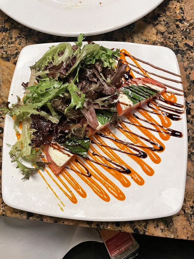 This isn't just a salad—it's a colorful canvas where greens, tomatoes, and cheese perform a synchronized dance under balsamic drizzles.
