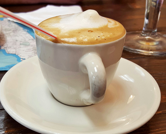 The café con leche arrives with a perfect foam crown – Miami's liquid energy that puts fancy coffee chains to shame.