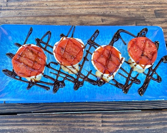 Tomatoes wearing a little black dress of balsamic. This elegant caprese presentation proves that sometimes the simplest combinations create the most profound flavors.