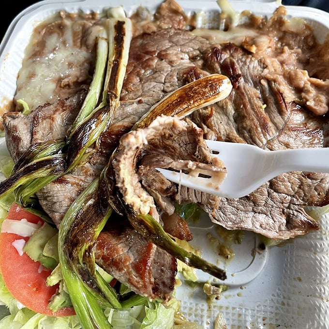 Carne asada so perfectly grilled, those charred green onions aren't garnish – they're backup dancers for the meat's main performance.