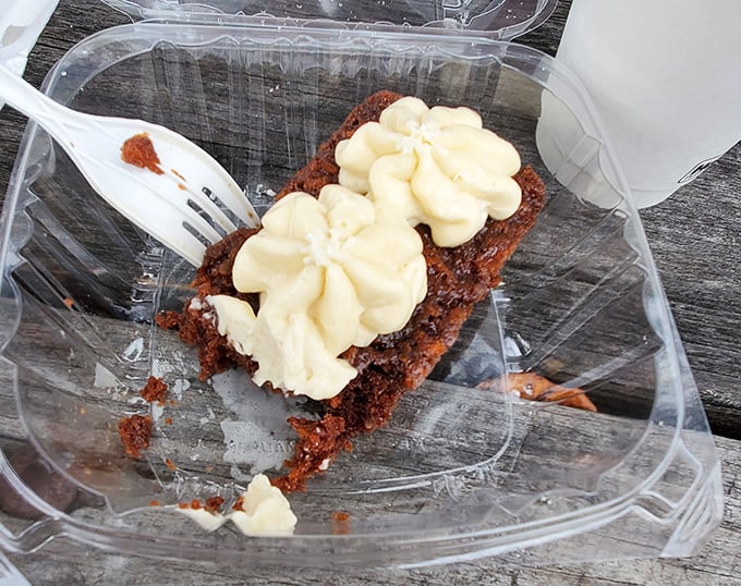 Carrot cake that makes you question why anyone would ever eat carrots any other way. Those cream cheese flowers aren't decoration—they're little dairy masterpieces.