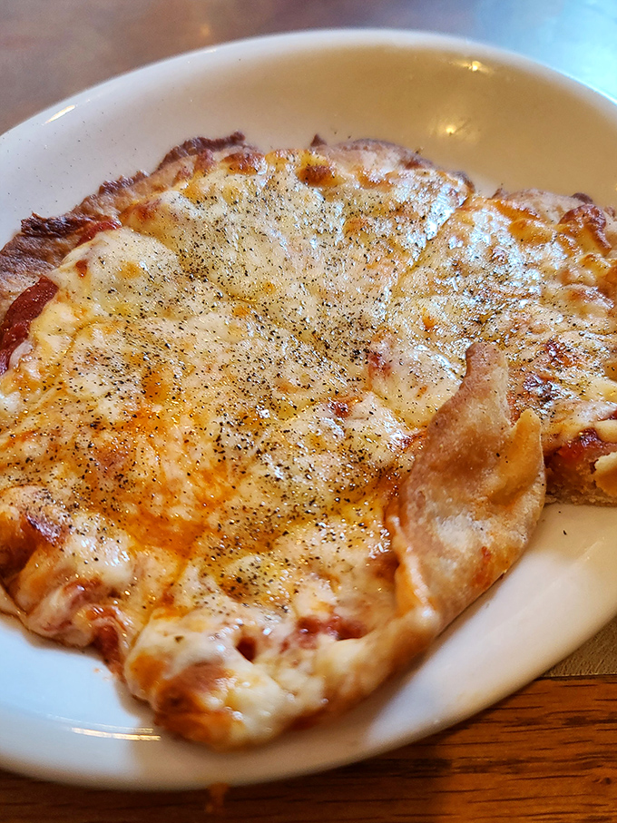 Pizza that reminds you why simple is often best—a perfect cheese-to-sauce ratio on that distinctive crust that the menu rightfully boasts about.