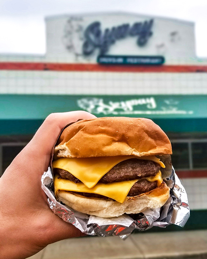 The cheeseburger in its natural habitat – posed against the Skyway sign, this beauty has more personality than most dating app profiles.