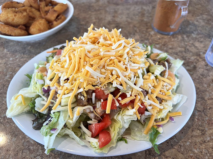 Garden-fresh ingredients piled high with shredded cheese—proof that "salad" doesn't have to be code for "sad lunch" in the right hands.