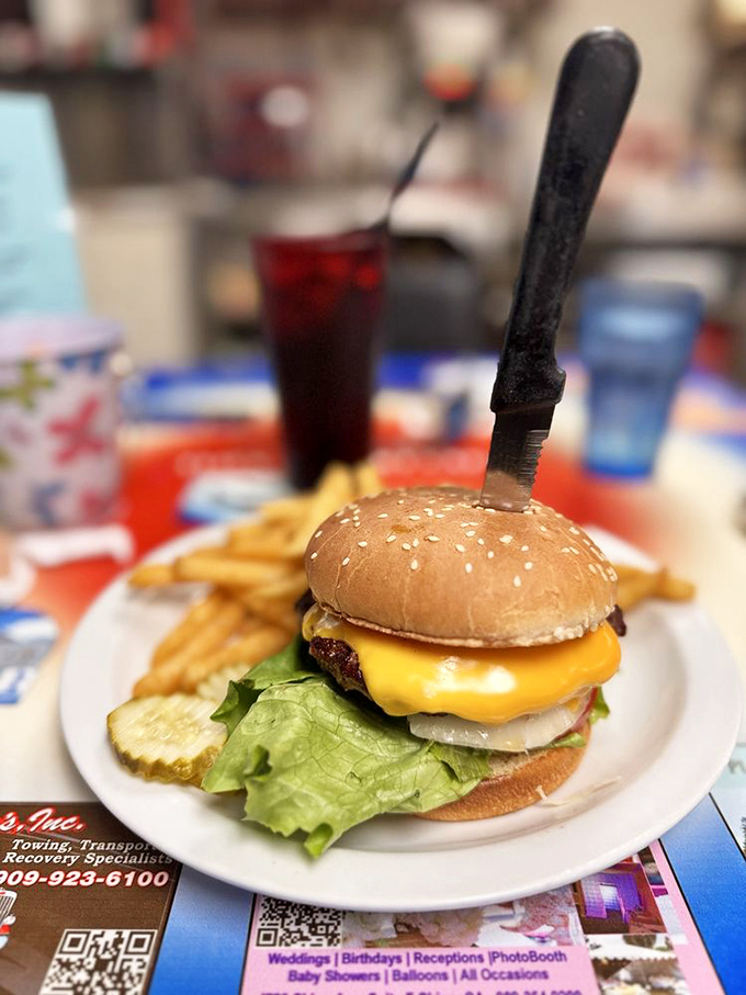 A classic American cheeseburger with the knife standing at attention – as if it knows it's guarding something truly special.