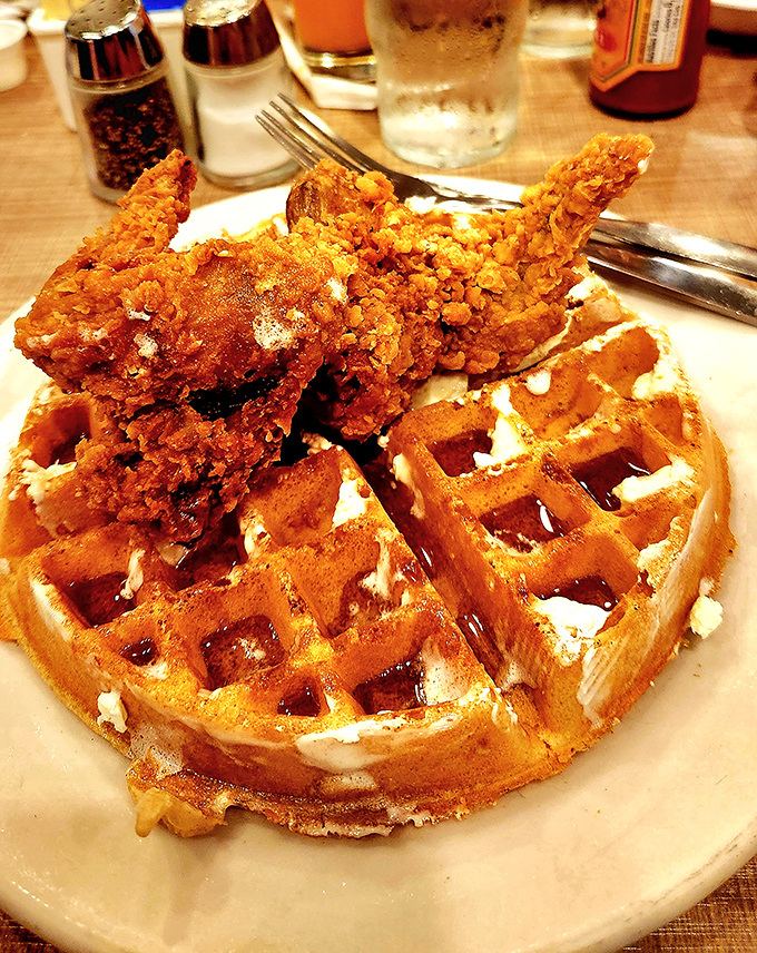 The chicken and waffles represent breakfast diplomacy at its finest—bringing together two foods that belong together like old friends reuniting after years apart.