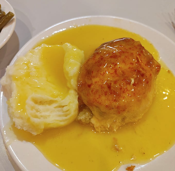 This chicken and dressing combo, bathed in golden gravy, is what comfort food dreams are made of – no Instagram filter required.