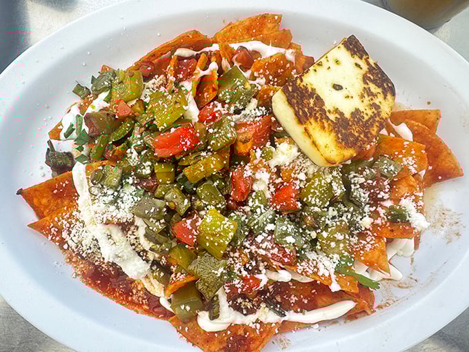 These chilaquiles aren't messing around—crispy tortilla chips smothered in sauce, cheese, and vegetables create the breakfast fiesta you deserve.