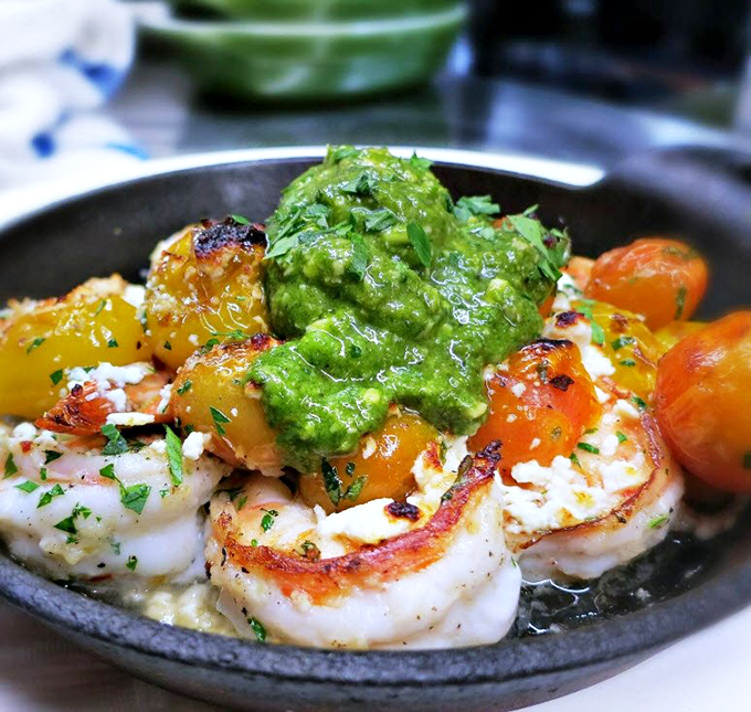 Sizzling prawns with vibrant salsa verde – proof that sometimes the simplest presentations deliver the most profound flavors.