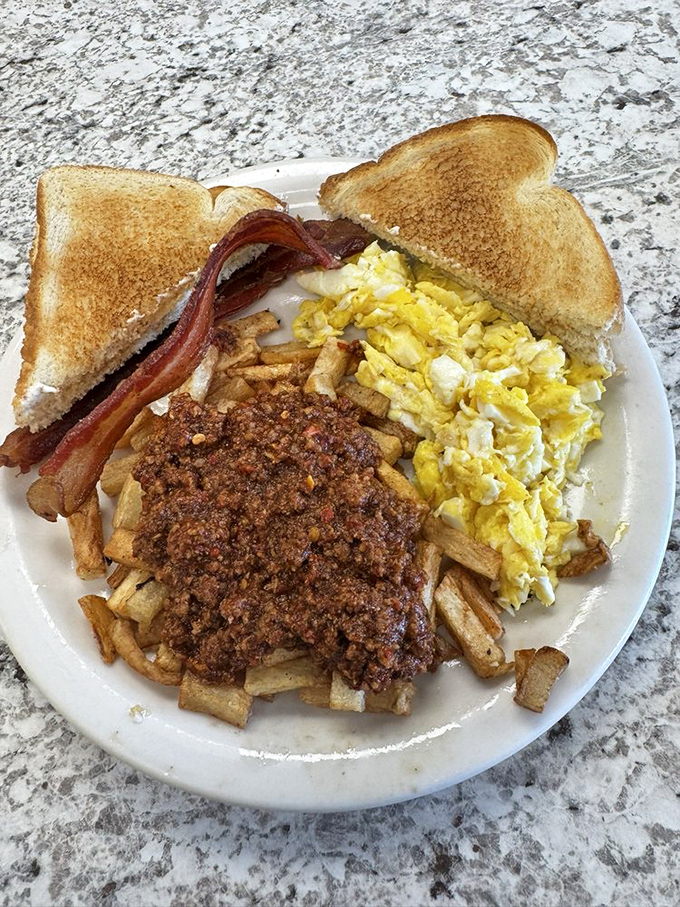 Chili-topped home fries, scrambled eggs, and toast—the breakfast equivalent of a warm hug from your favorite aunt who always sneaks you extra dessert.