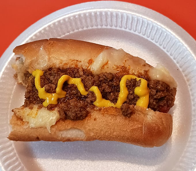 The chili dog—where spiced meat sauce cascades over a hot dog like lava, creating a beautiful disaster you'll happily clean up with every bite.