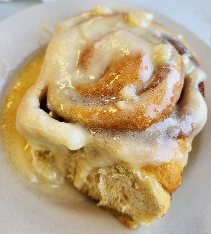 This cinnamon roll isn't just breakfast—it's dessert with a permission slip. The icing pools like a sweet lagoon you'll want to swim in.